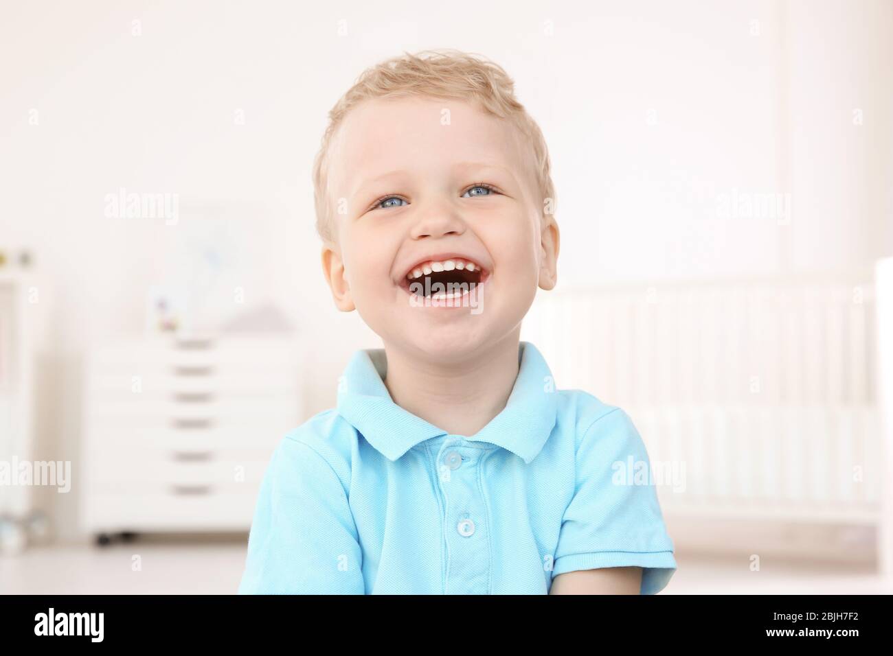 Cute little boy laughing at home Stock Photo - Alamy