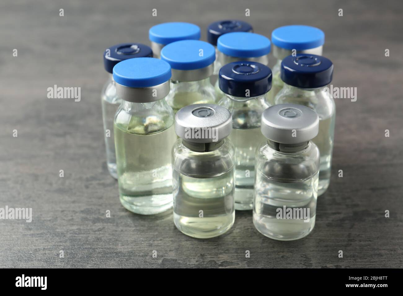 Medical ampules on grunge background. Vaccination concept Stock Photo ...