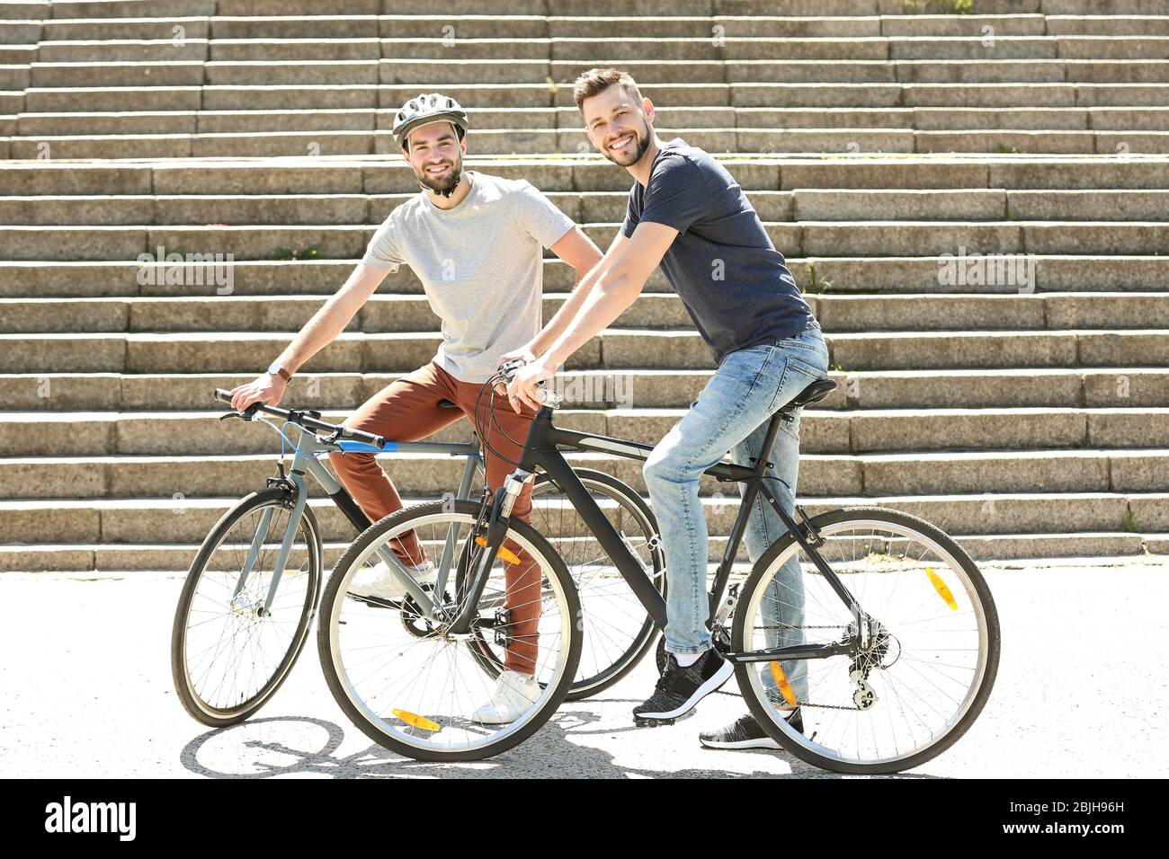 Handsome young men with bicycles outdoors on sunny day Stock Photo - Alamy