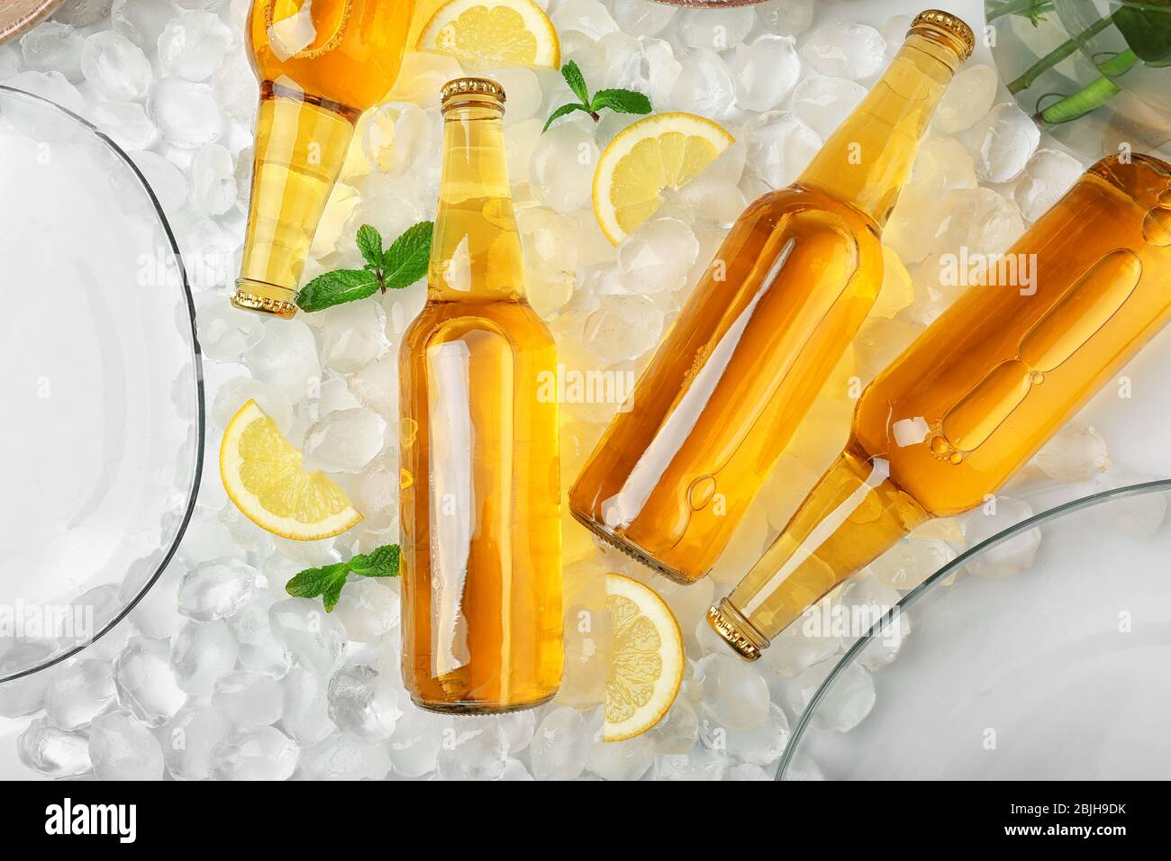 Bottles of lemonade on ice background Stock Photo - Alamy