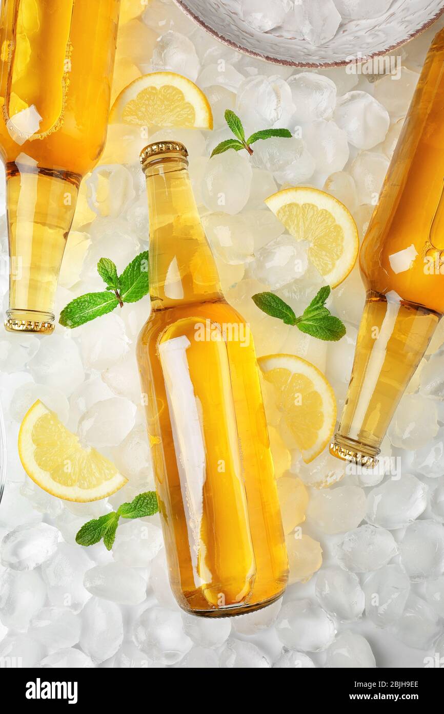 Bottles of lemonade on ice background Stock Photo - Alamy