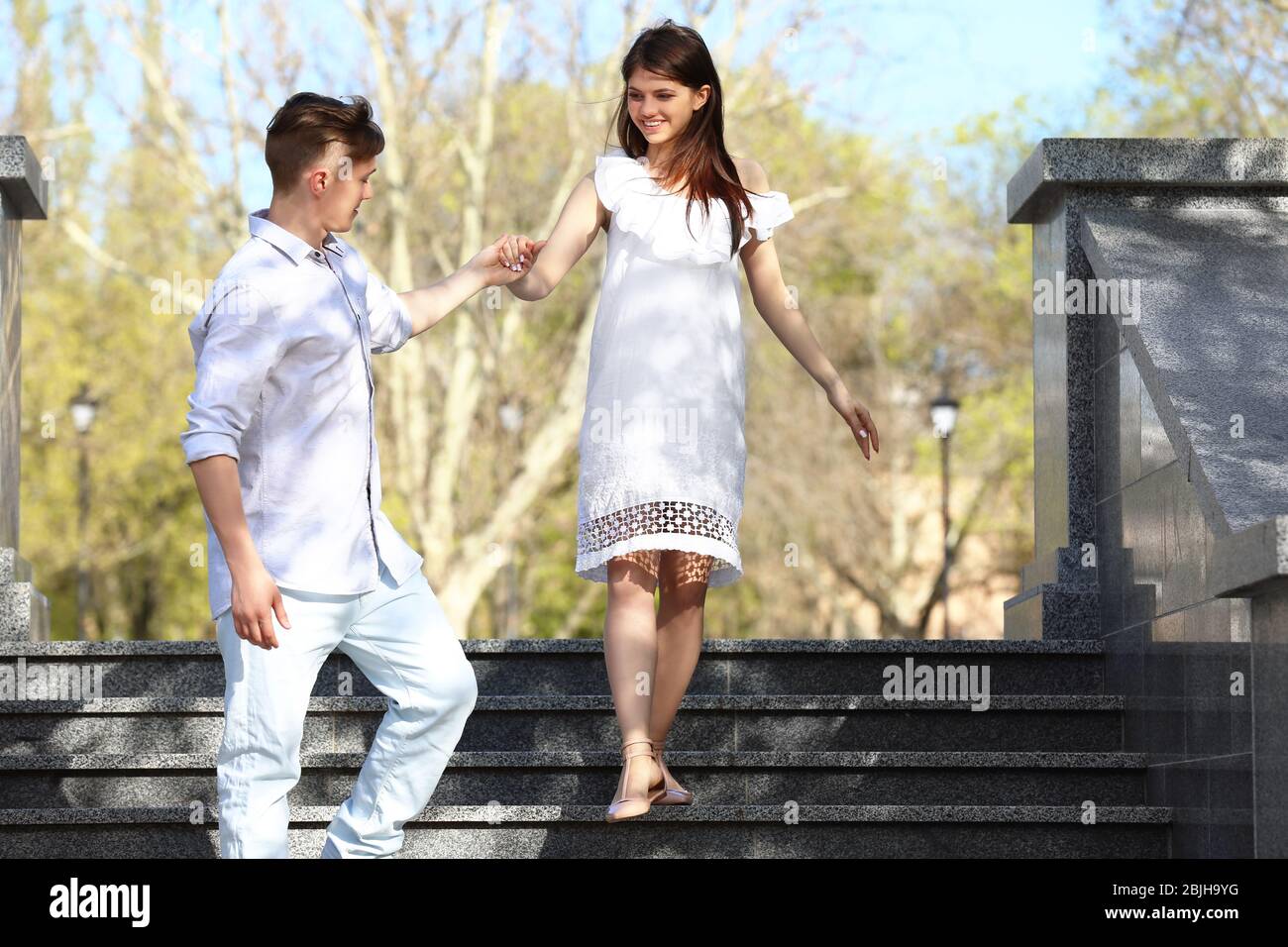 Young couple walking down stairs hi-res stock photography and images ...
