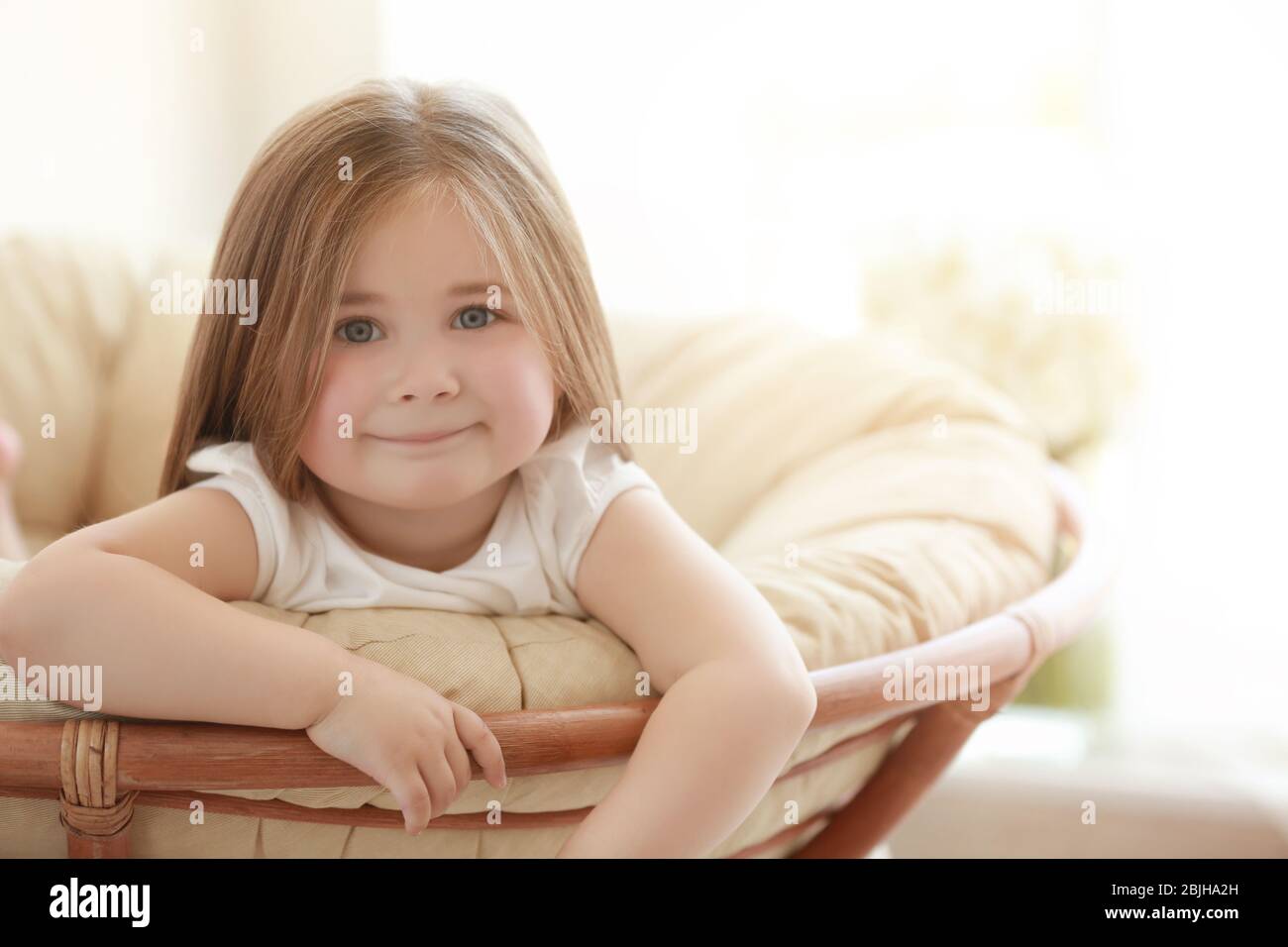 Cute little girl resting on lounge at home Stock Photo - Alamy