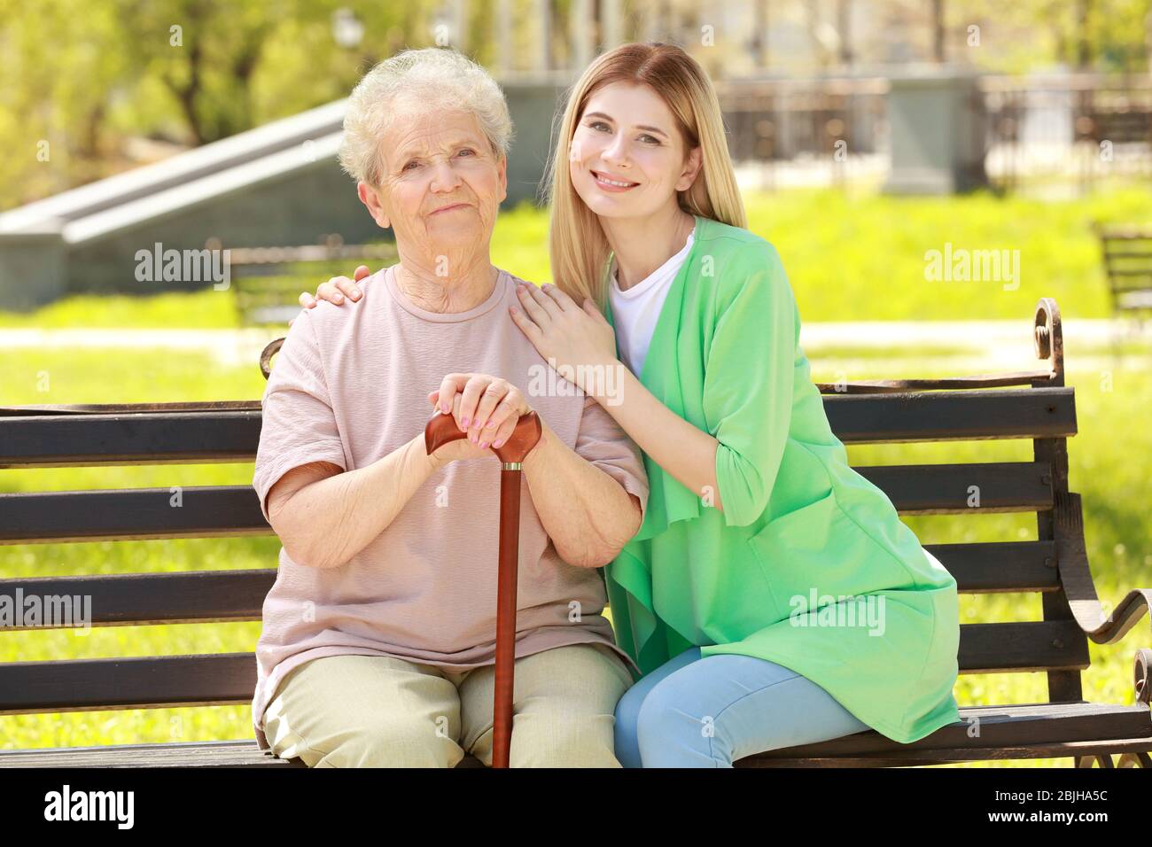 Elderly woman adult daughter on bench hi-res stock photography and ...