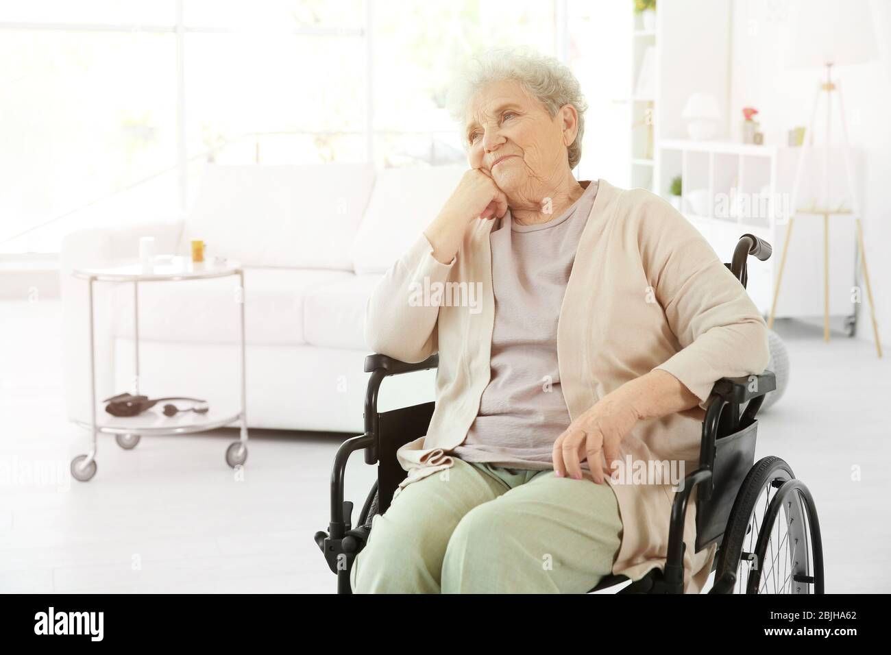 Disabled elderly woman in wheelchair at home Stock Photo - Alamy