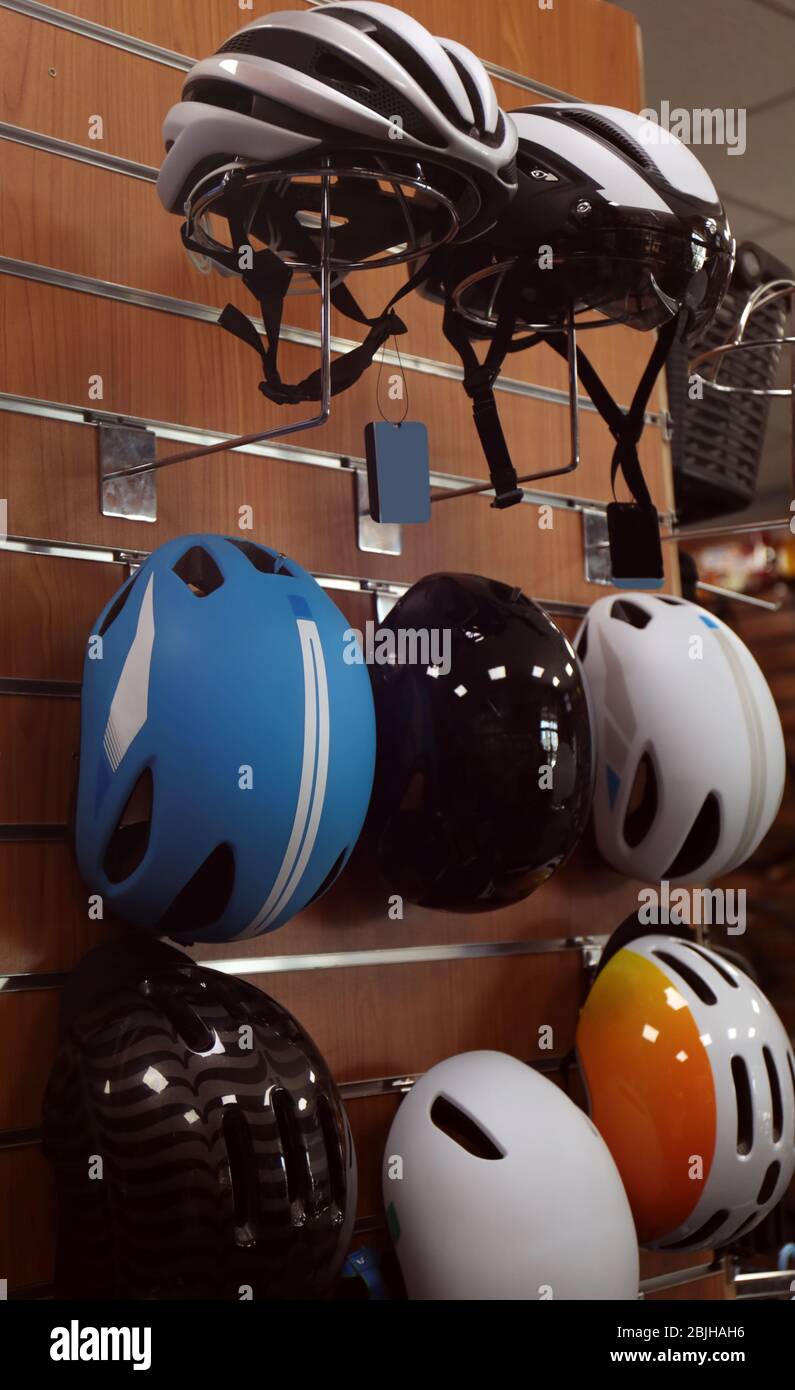 Stand with helmets in bicycle shop Stock Photo - Alamy