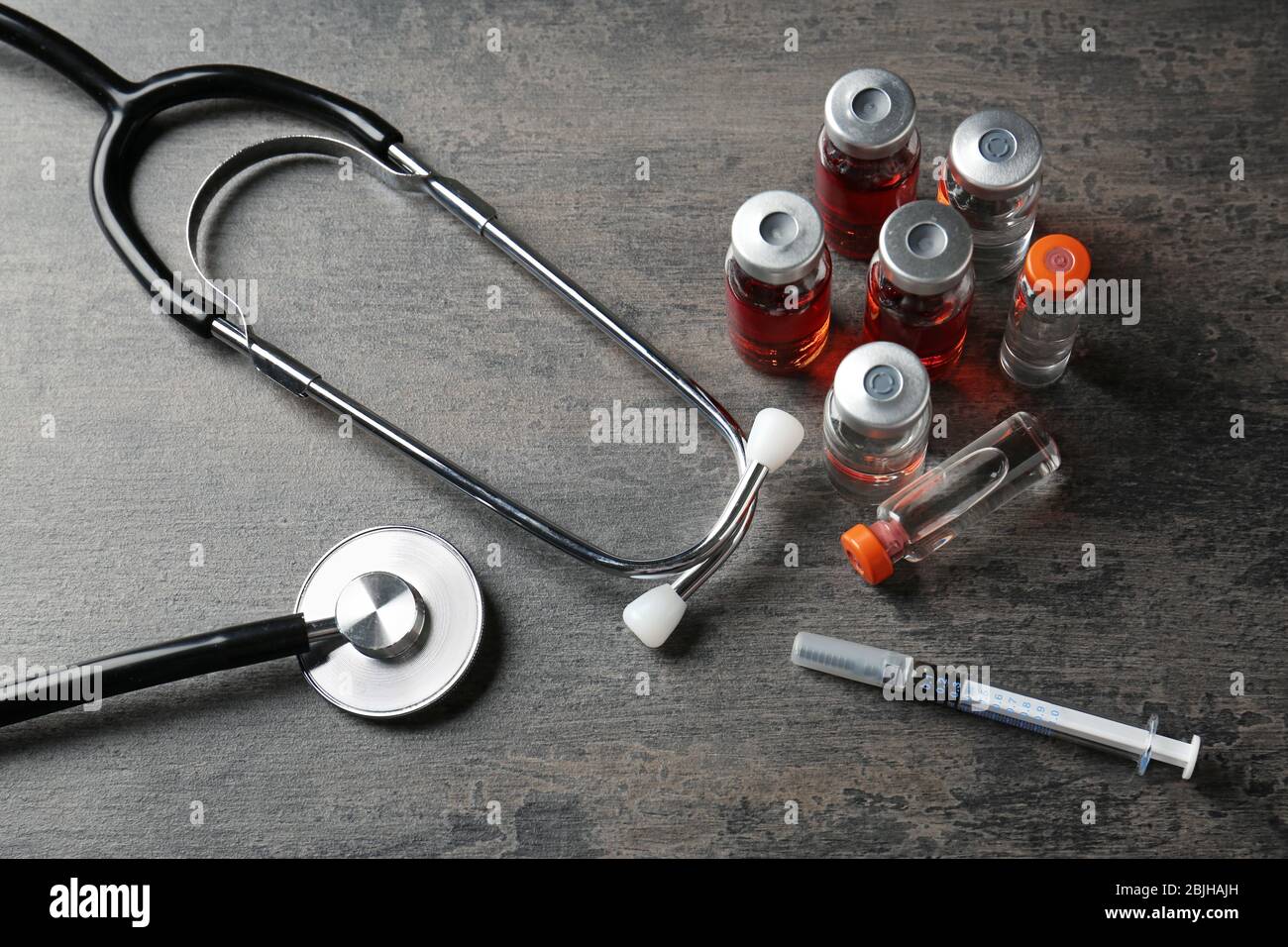 Ampules with vaccine, syringe and stethoscope on table Stock Photo - Alamy
