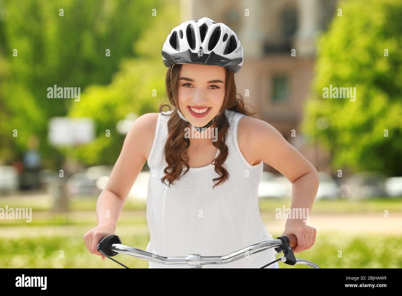 Beautiful young woman riding bicycle hi-res stock photography and images - Alamy