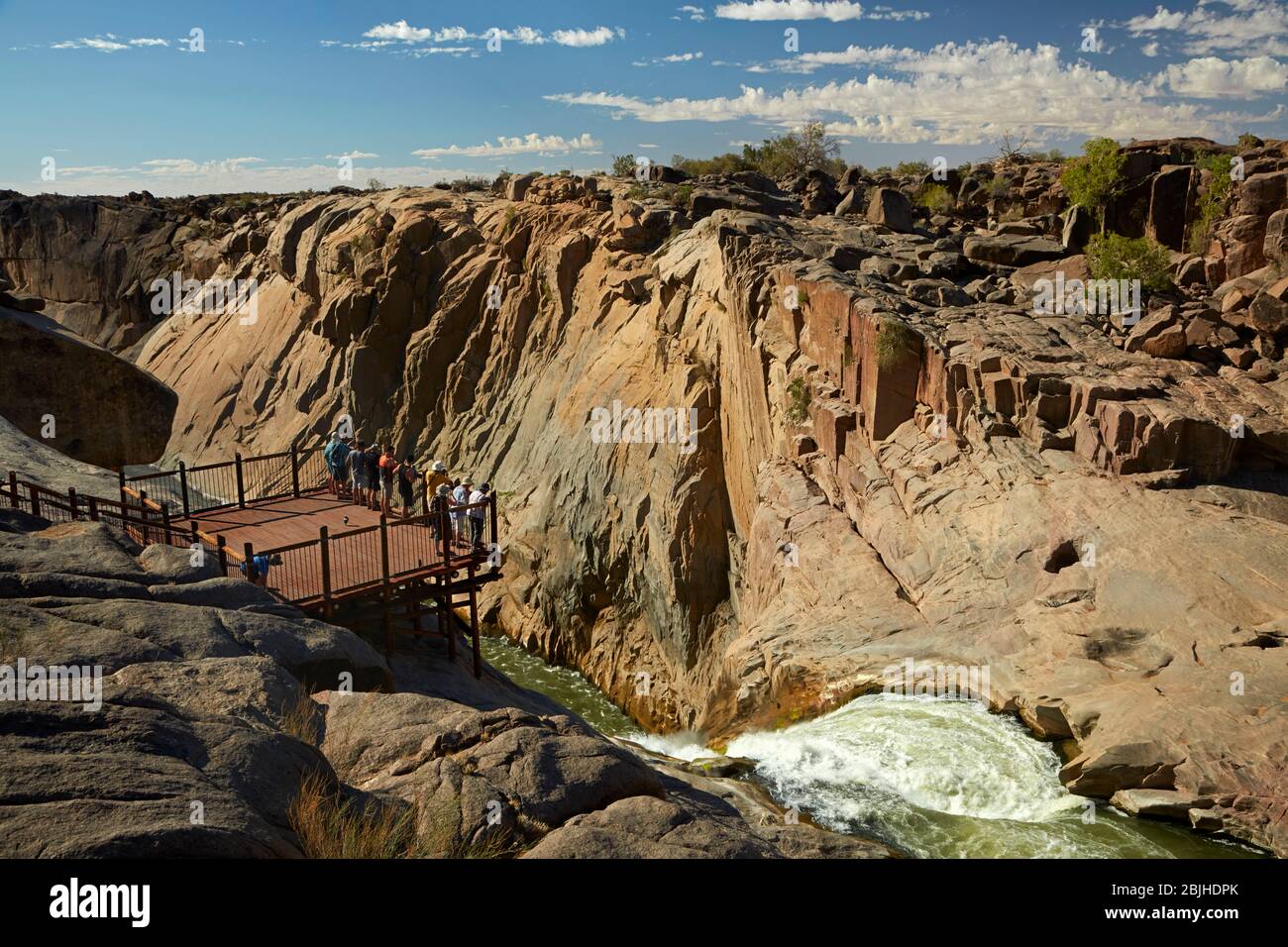 Tourists on viewing platform looking at Augrabies Falls on Orange River ...