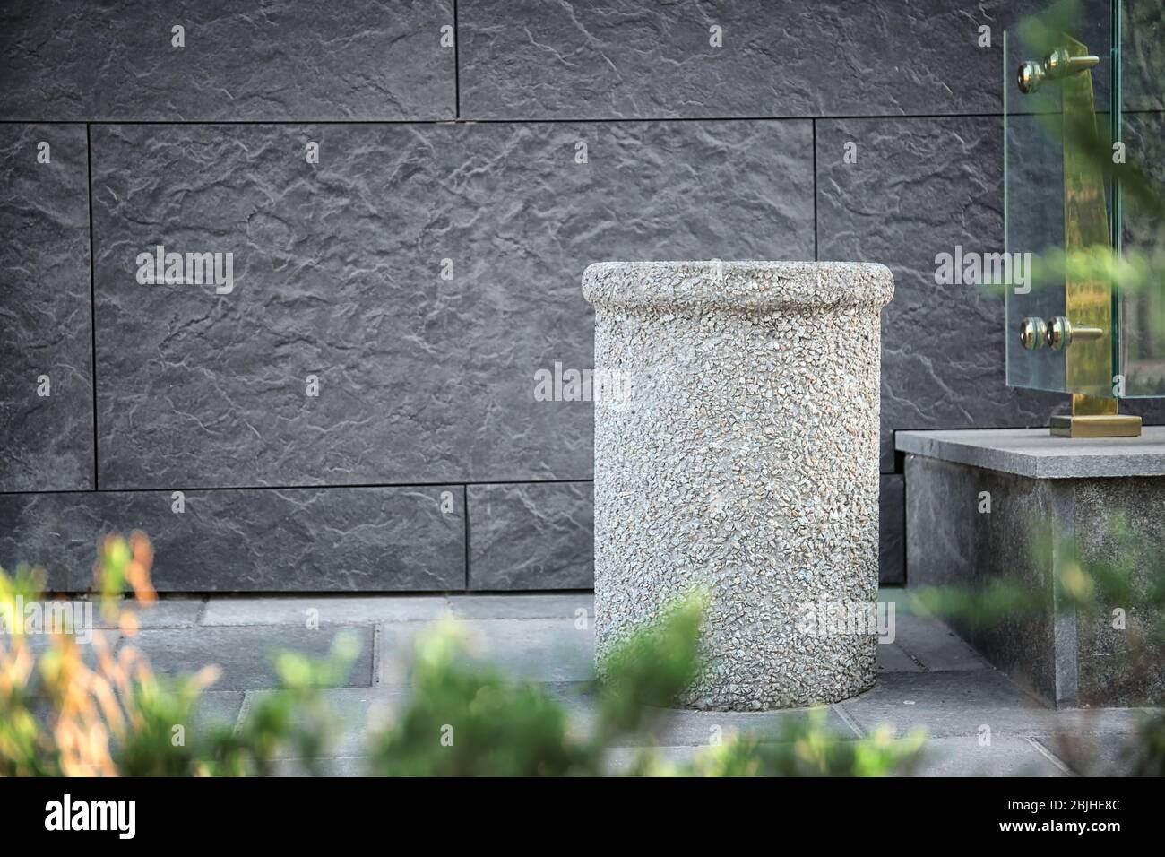 Stone bin on street Stock Photo - Alamy