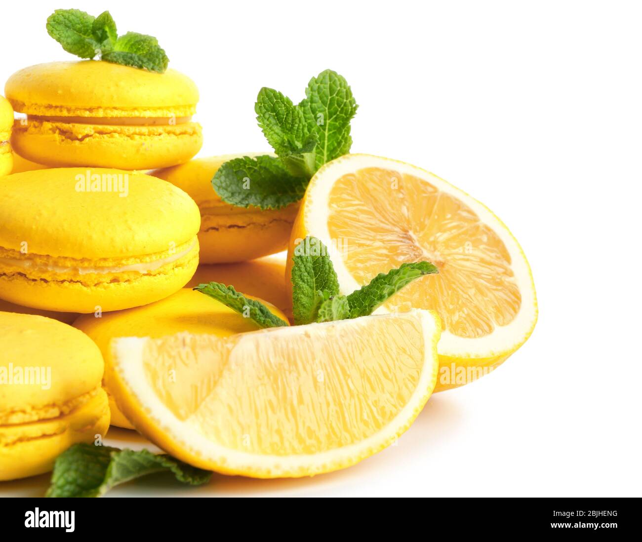 Lemon macarons and sliced fruit on white background Stock Photo - Alamy