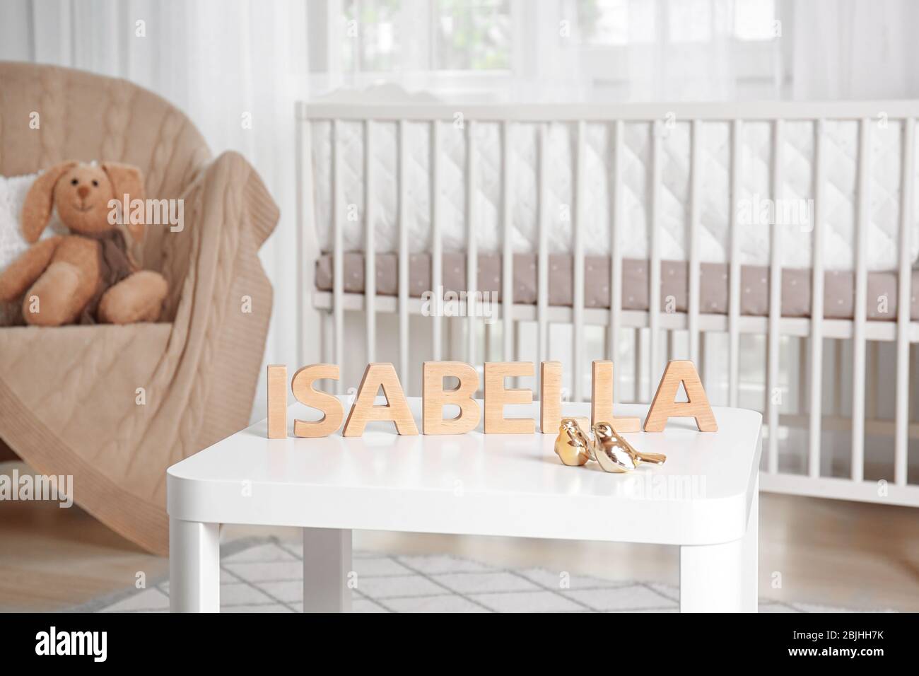 Baby name ISABELLA composed of wooden letters on table. Choosing name ...