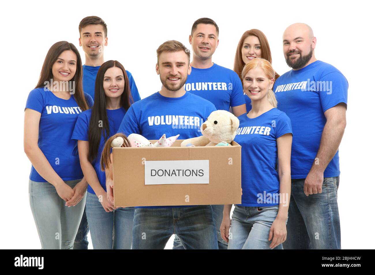 Young volunteers with box of donations on white background Stock Photo ...