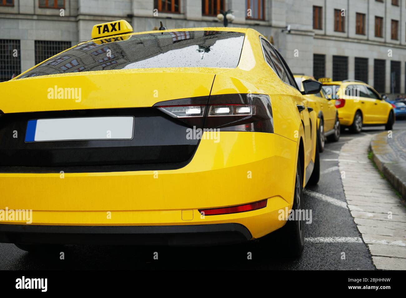 Rear view of yellow taxi on street Stock Photo - Alamy