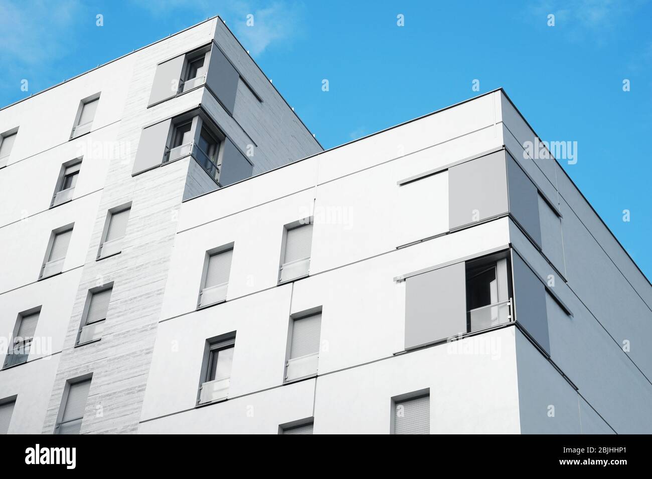 Modern building with windows on sky background Stock Photo - Alamy