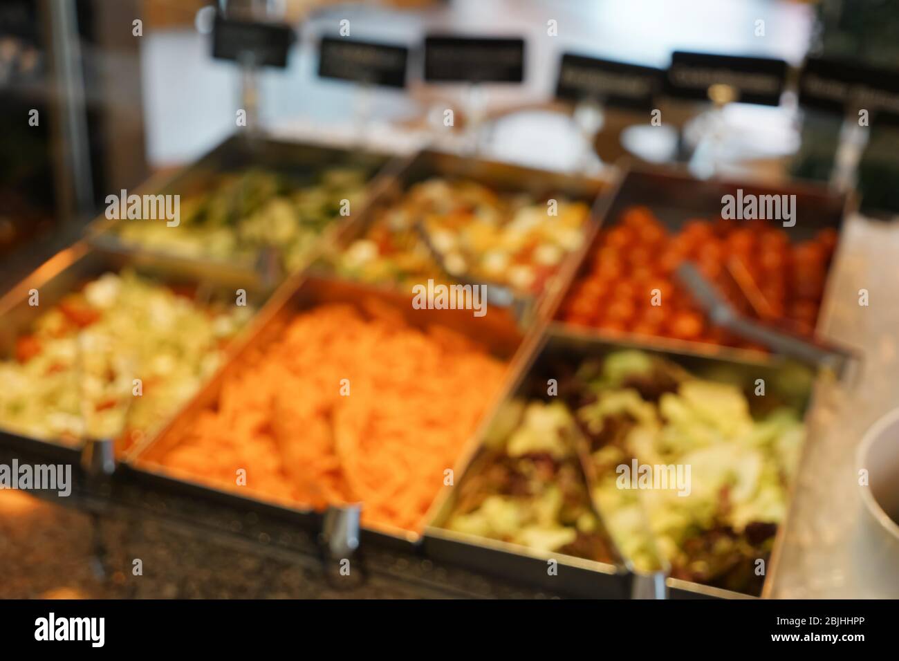 Stand with delicious food in cafeteria, blurred view Stock Photo - Alamy