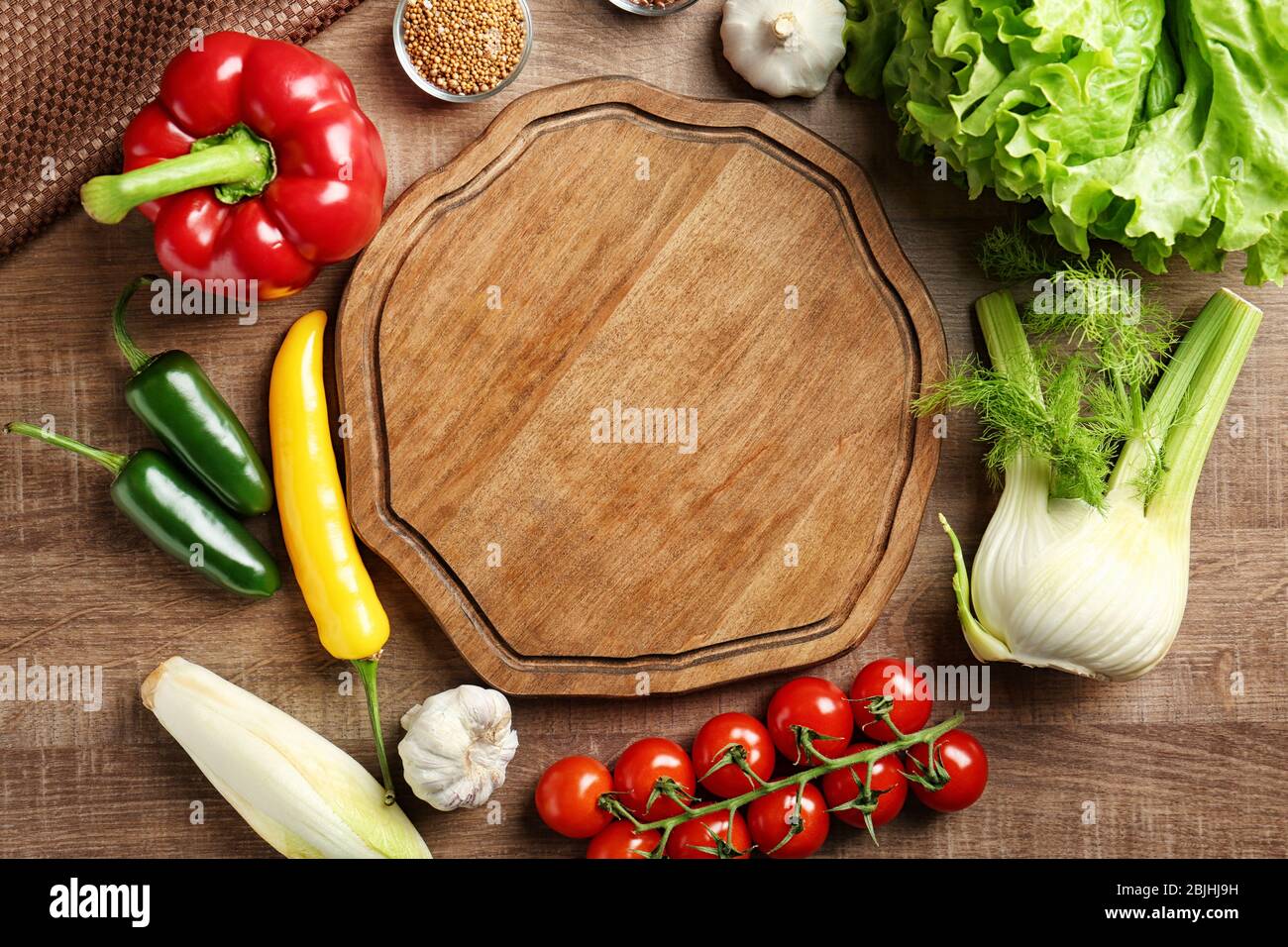 Wooden board and vegetables on kitchen table. Cooking classes concept ...