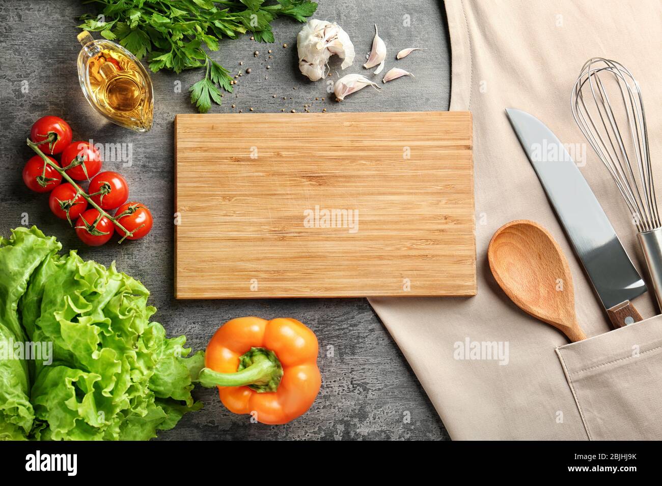Wooden board and vegetables on kitchen table. Cooking classes concept ...
