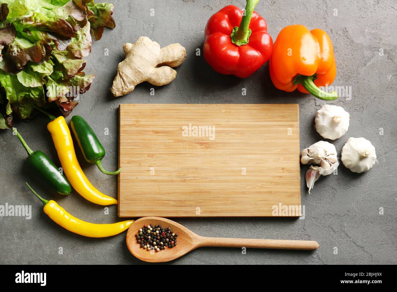 Wooden board and vegetables on kitchen table. Cooking classes concept ...