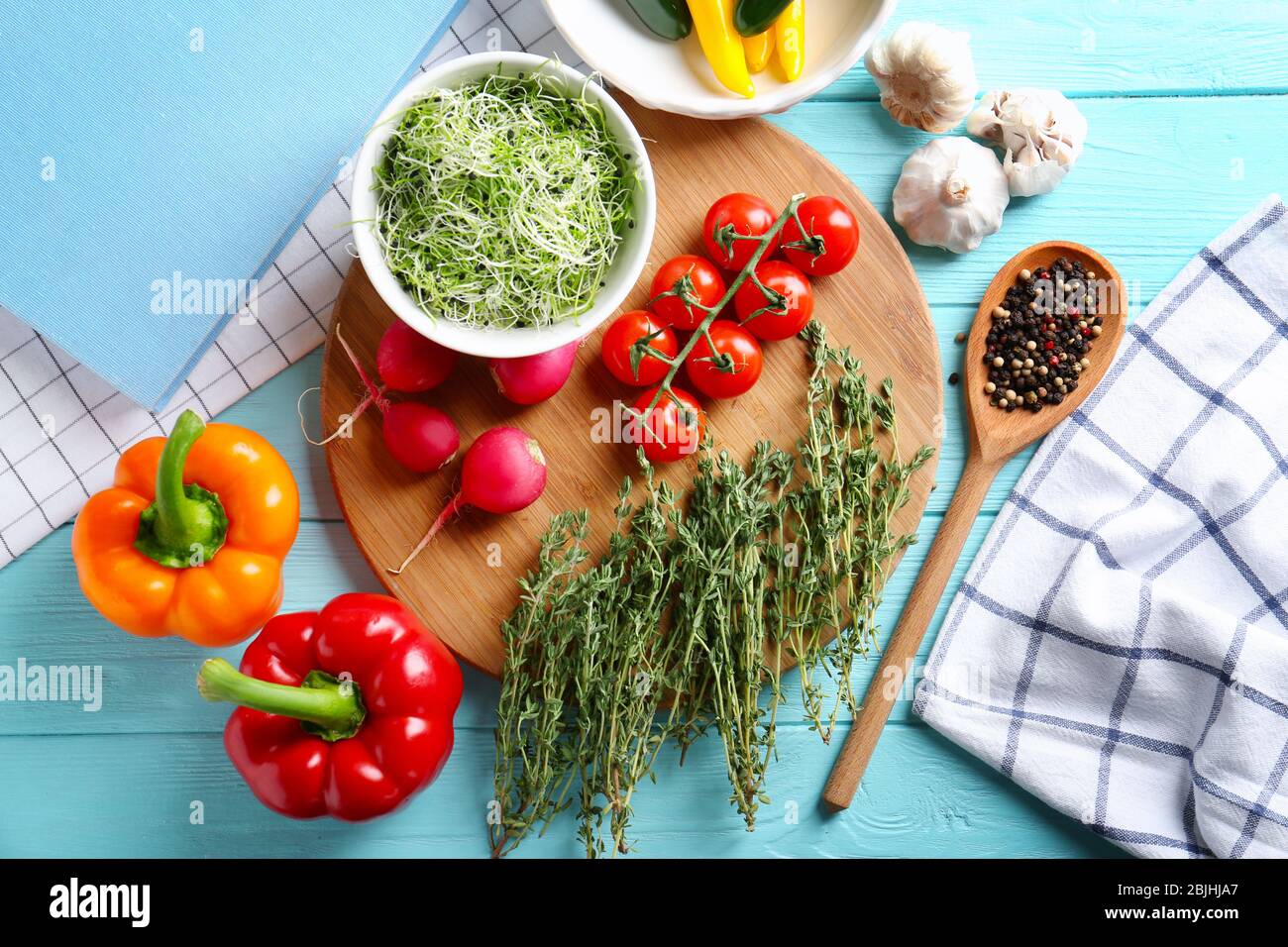 Wooden board with vegetables on kitchen table. Cooking classes concept ...