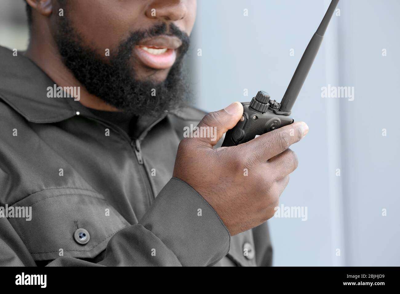 Male security guard using portable radio transmitter outdoors Stock ...