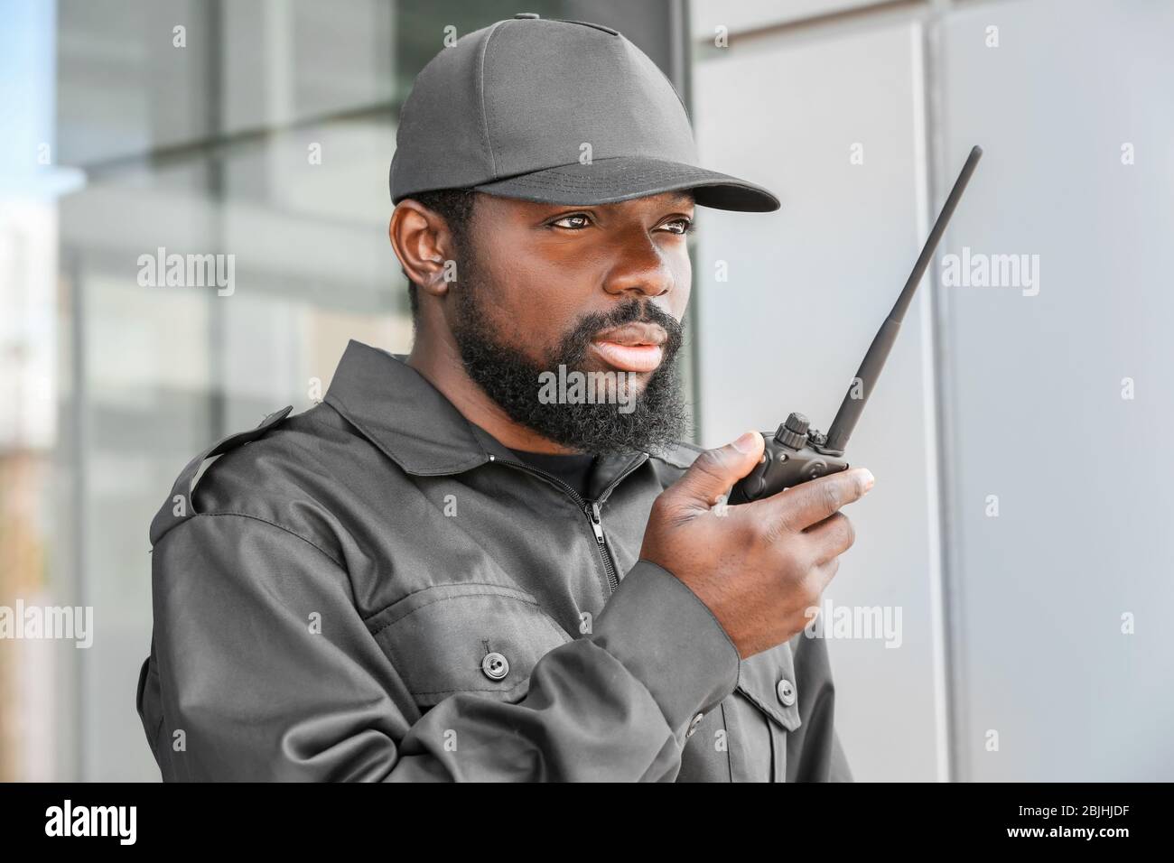 Male security guard using portable radio transmitter outdoors Stock ...