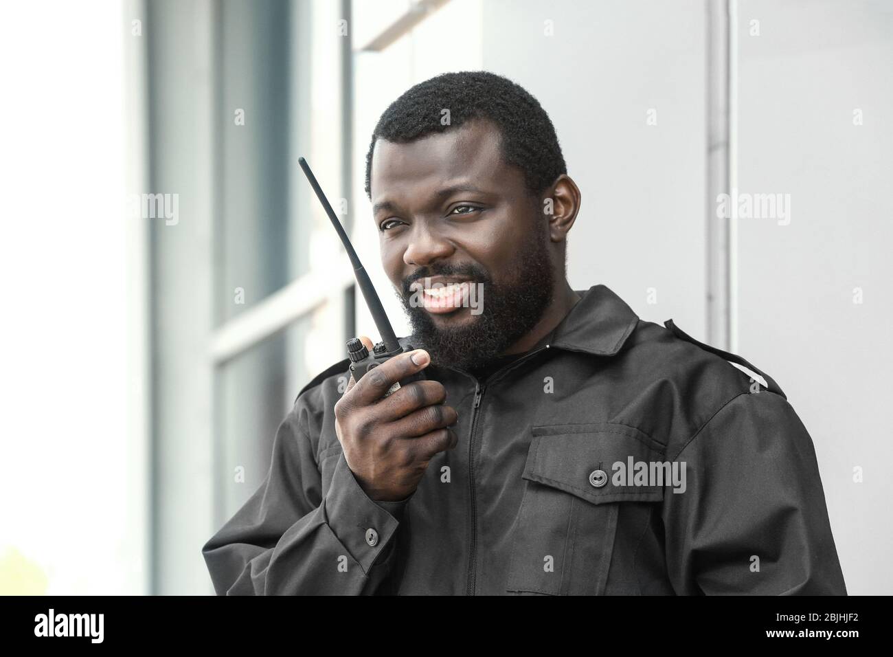 Male security guard using portable radio transmitter outdoors Stock ...