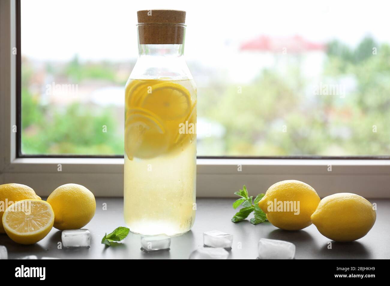 Bottle of fresh lemonade on window sill Stock Photo - Alamy