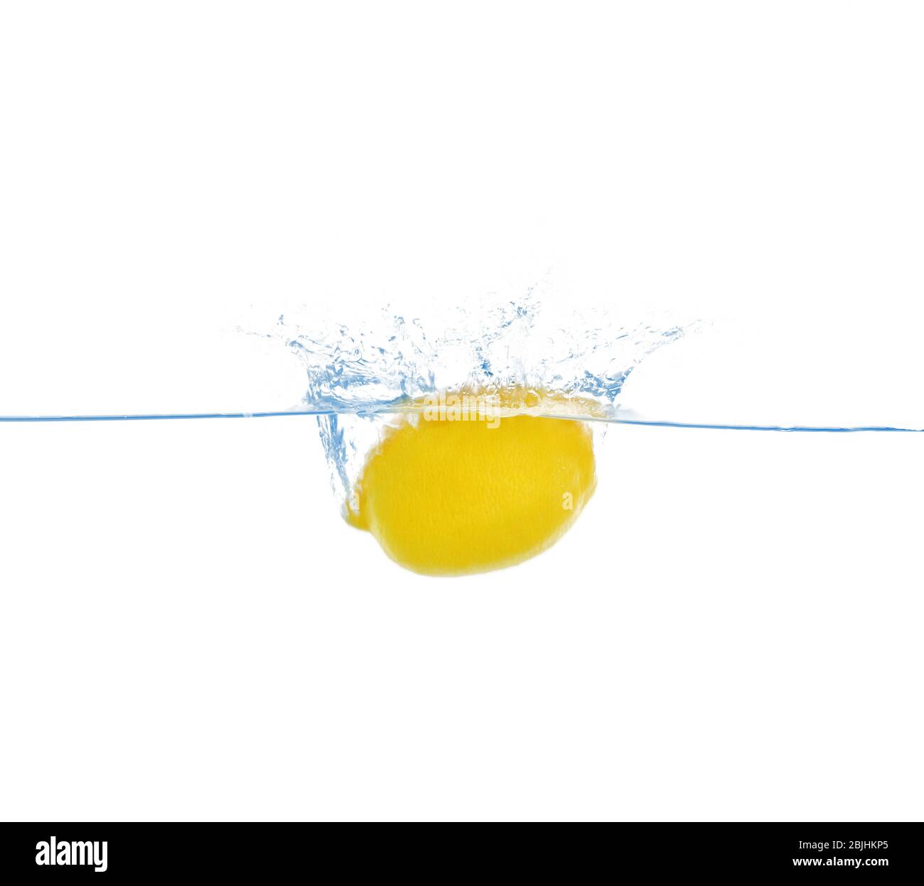 Lemon in water on white background Stock Photo - Alamy