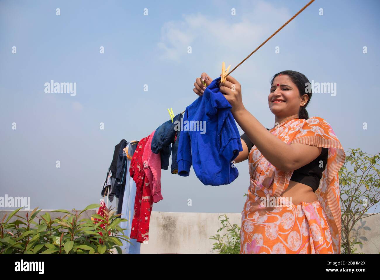 Indian woman drying clothes hi-res stock photography and images - Alamy