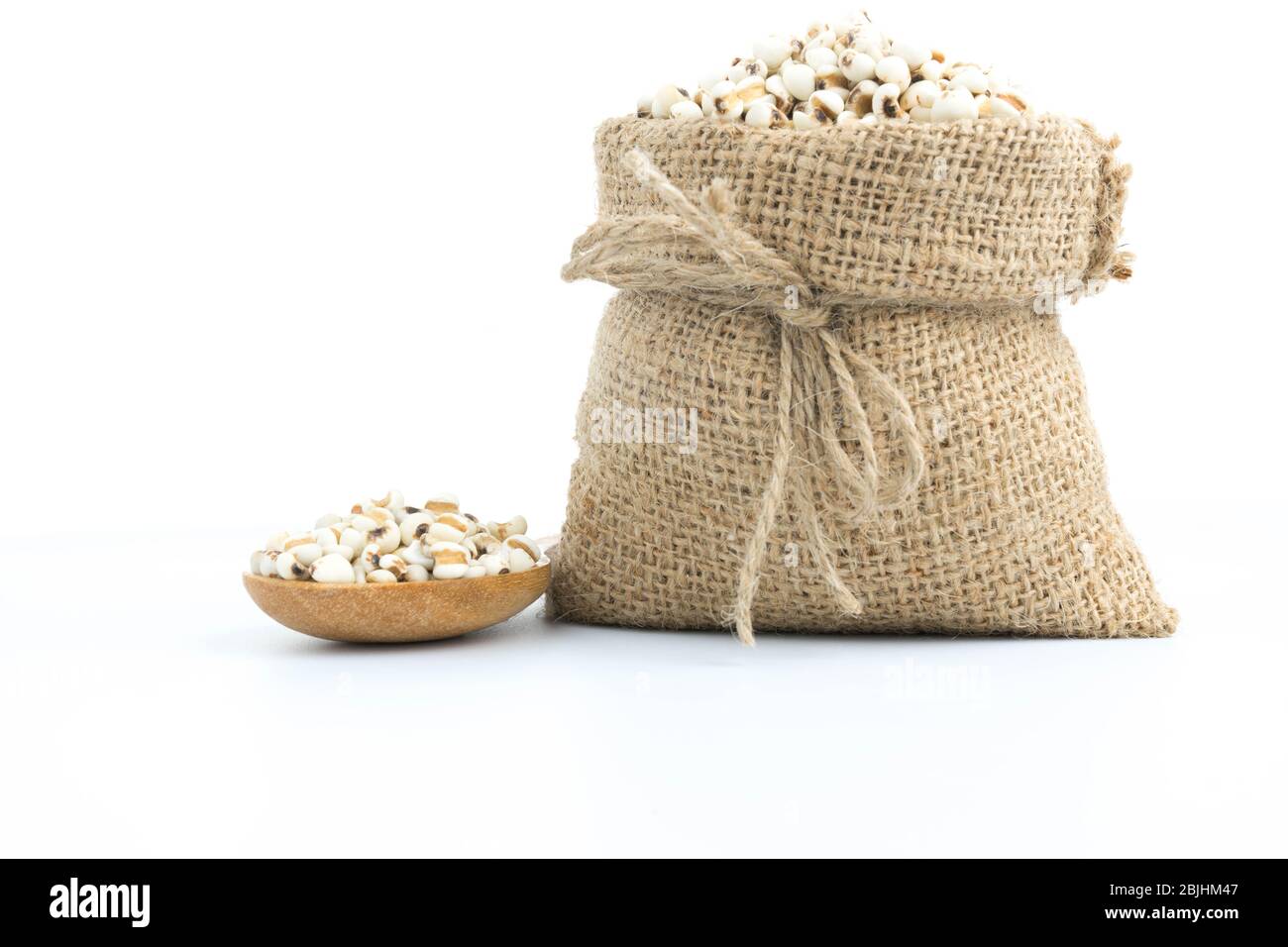 Millet in canvas sack on white background Stock Photo - Alamy