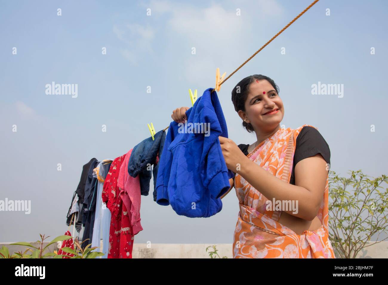 indian woman drying clothes on clothesline Stock Photo - Alamy