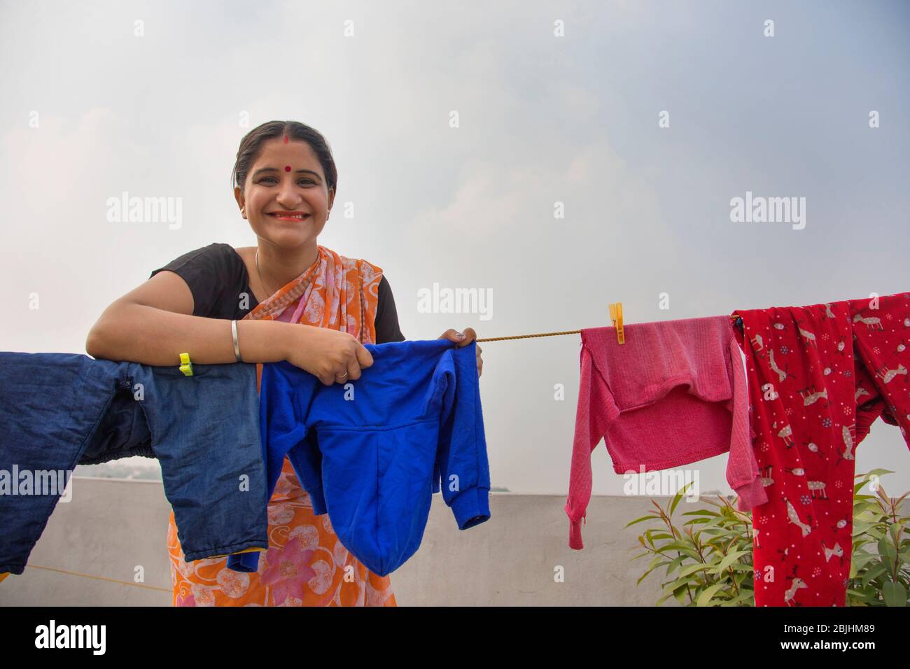 Indian woman drying clothes hi-res stock photography and images - Alamy