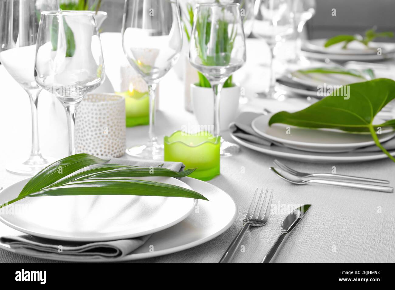 Beautiful table setting with green tropical leaves Stock Photo - Alamy