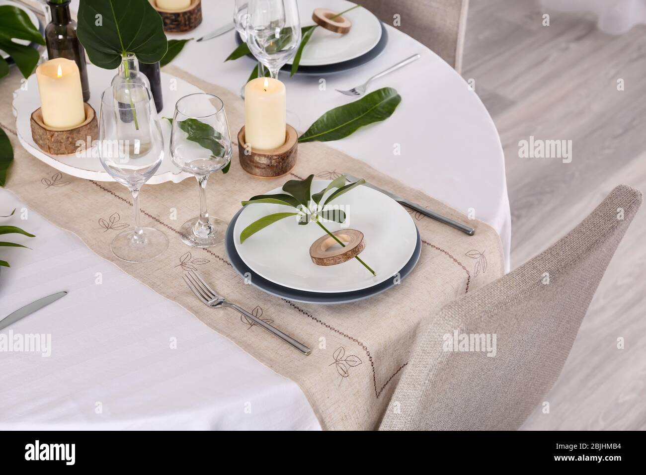 Beautiful table setting with green tropical leaves Stock Photo - Alamy
