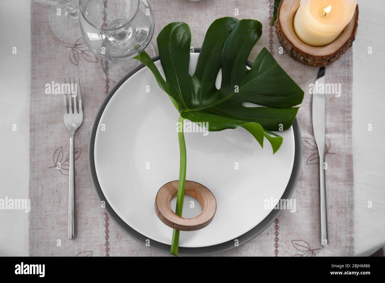 Beautiful table setting with green tropical leaf Stock Photo - Alamy