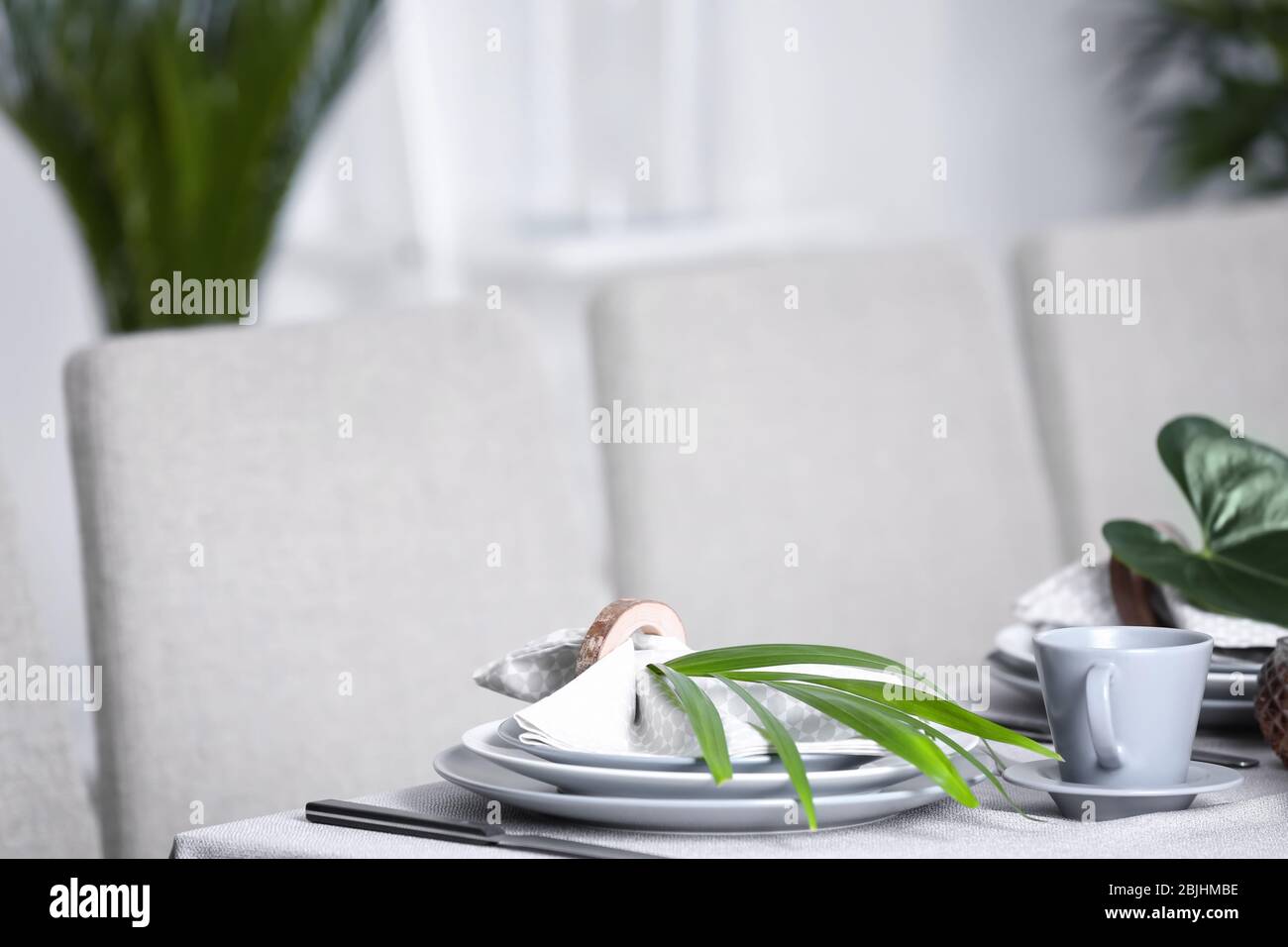 Beautiful table setting with green tropical leaves Stock Photo - Alamy