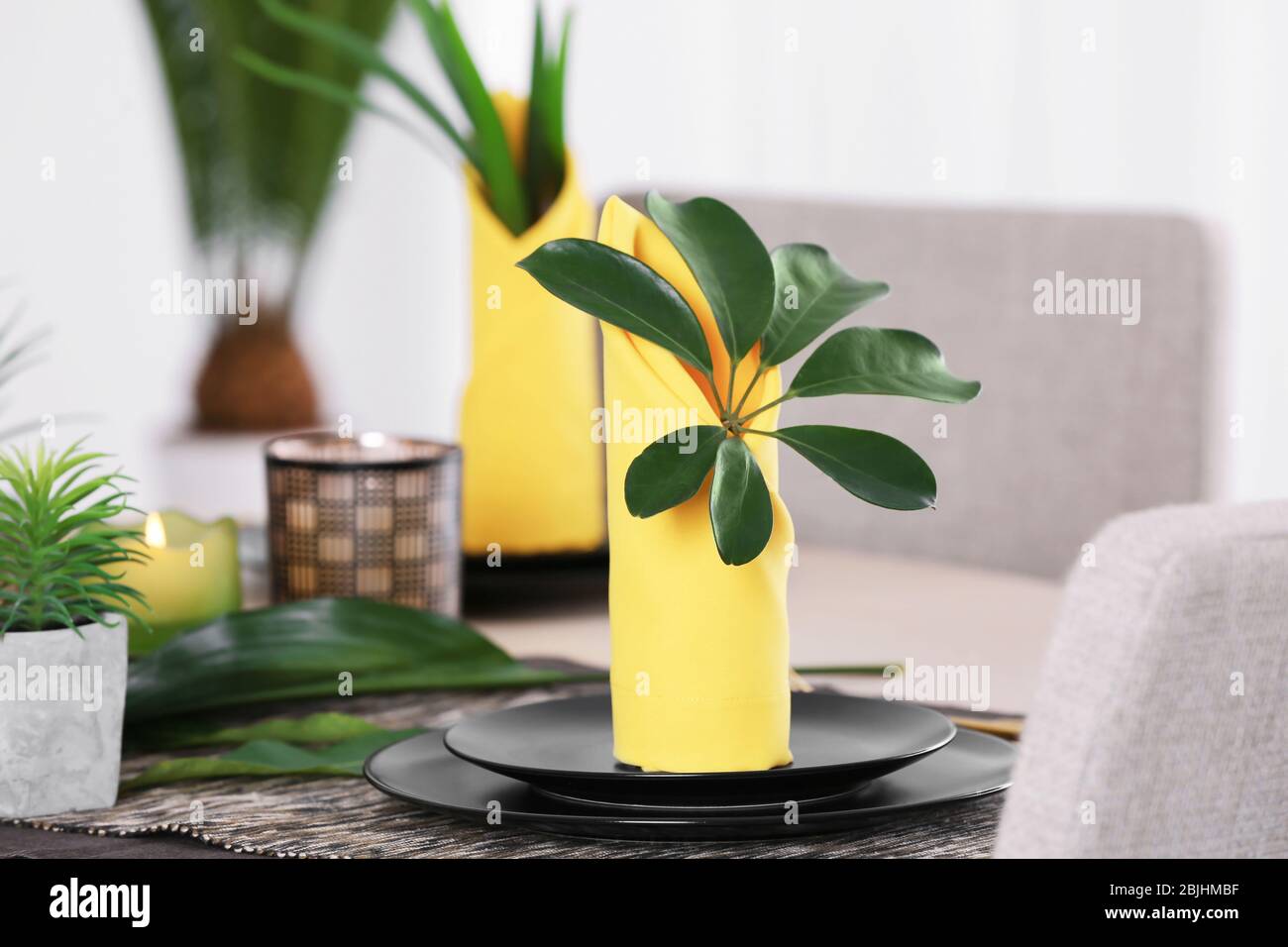 Beautiful table setting with green tropical leaves Stock Photo - Alamy