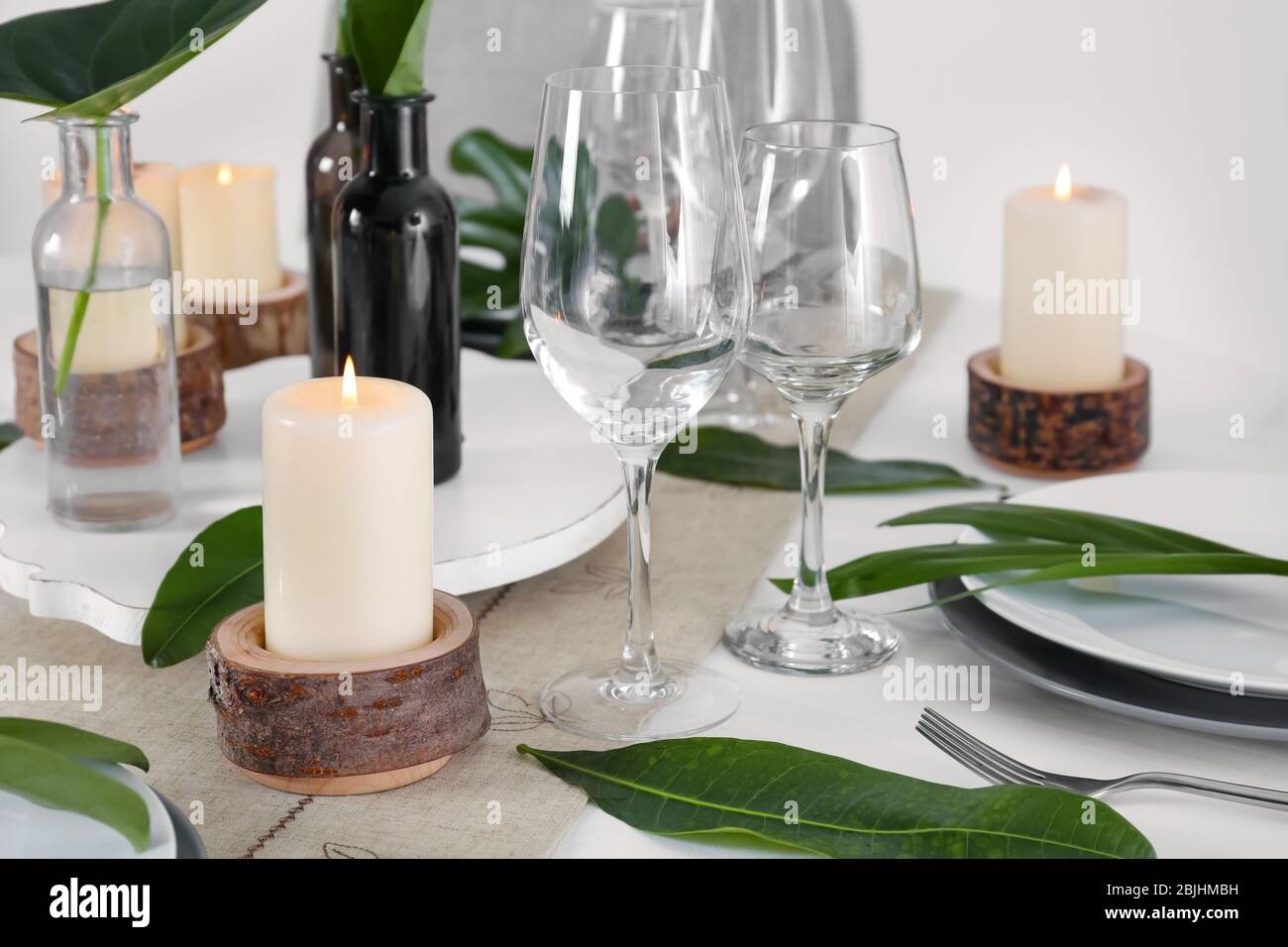 Beautiful table setting with green tropical leaves Stock Photo - Alamy