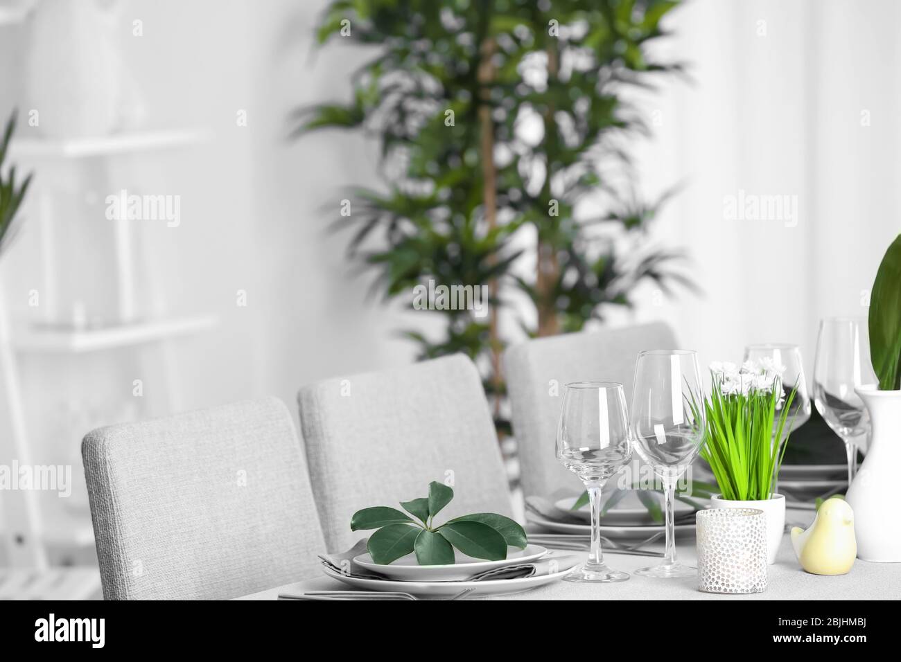 Beautiful table setting with green tropical leaves Stock Photo - Alamy
