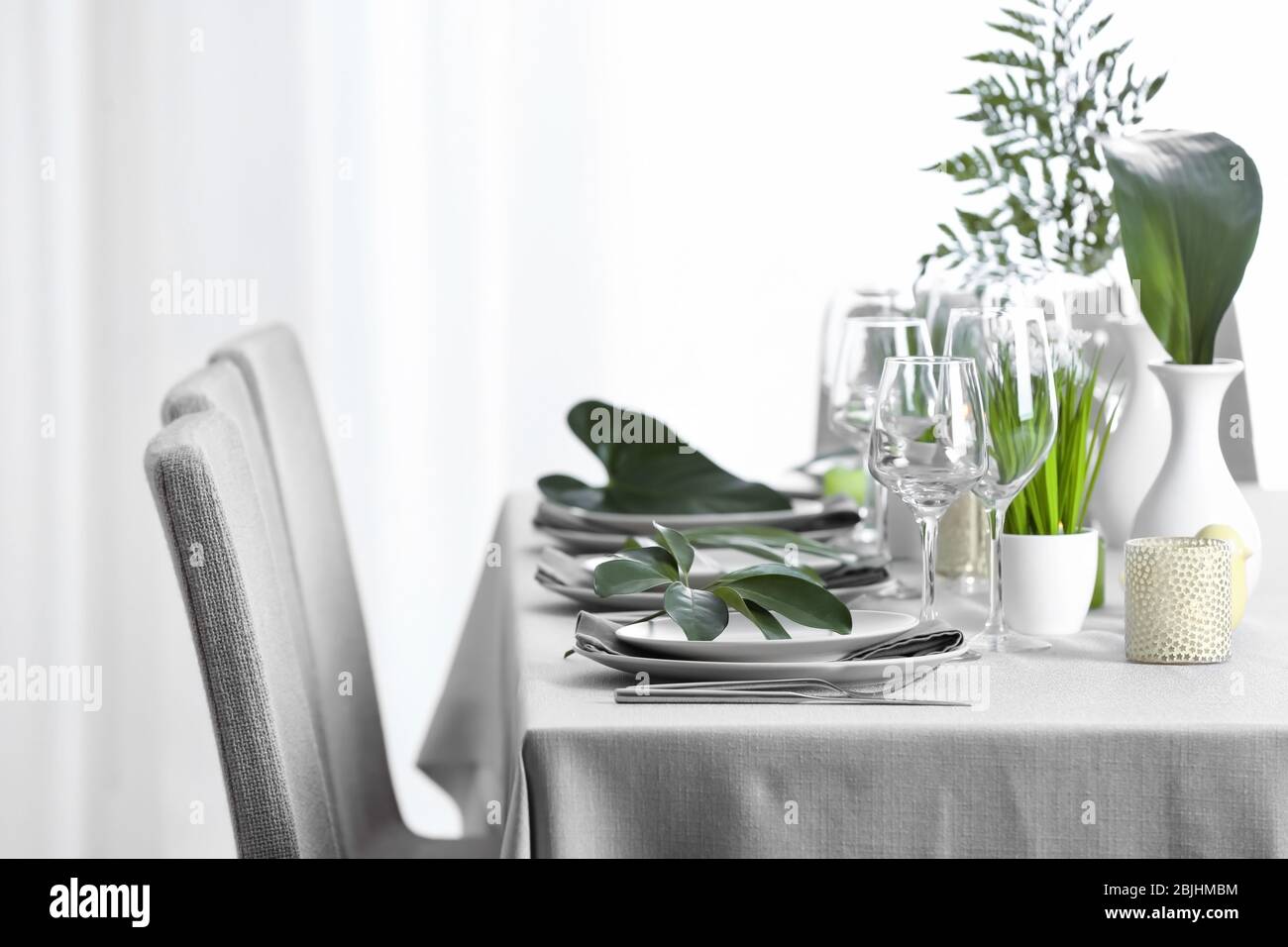 Beautiful table setting with green tropical leaves Stock Photo - Alamy