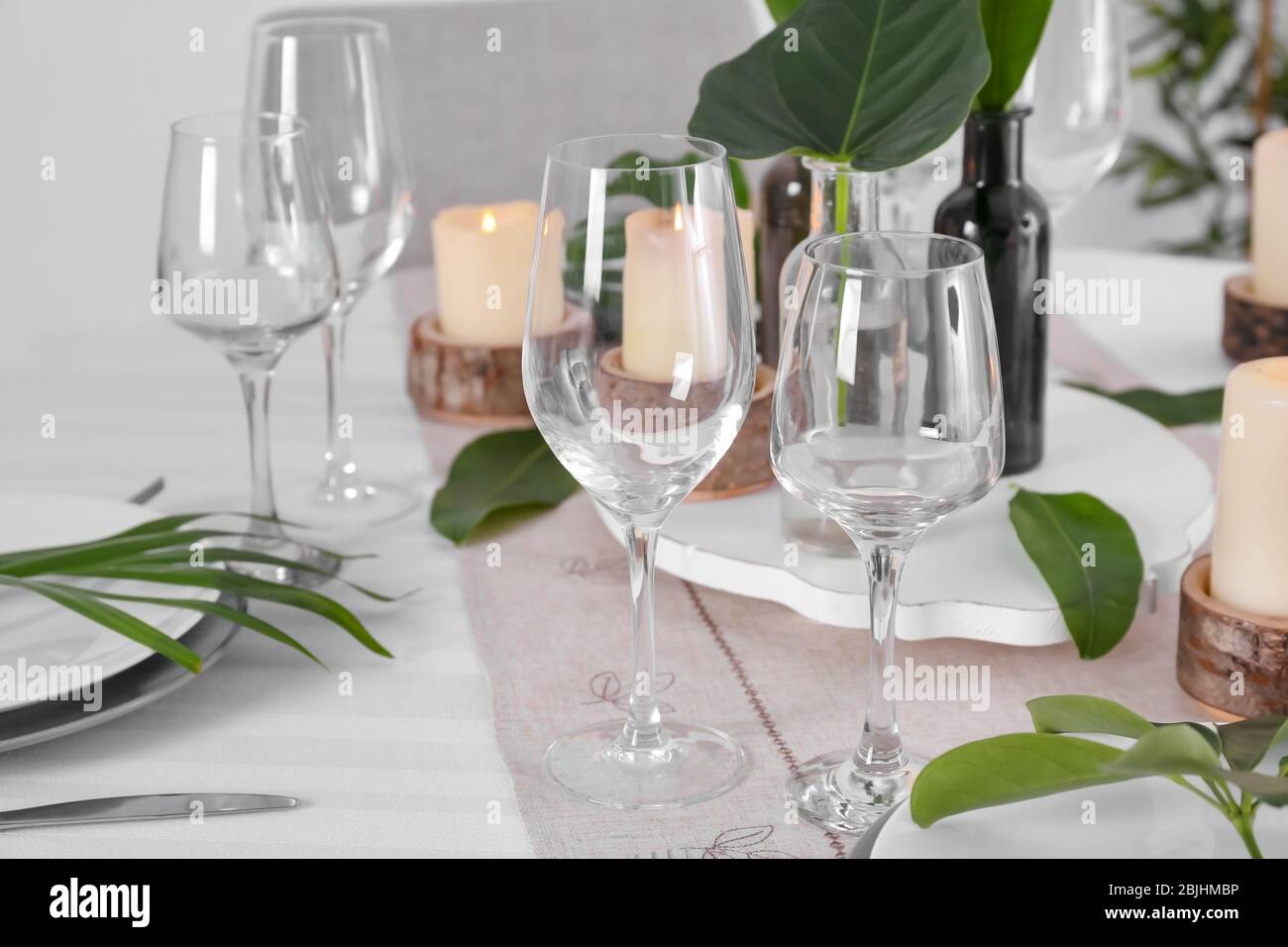 Beautiful table setting with green tropical leaves Stock Photo - Alamy