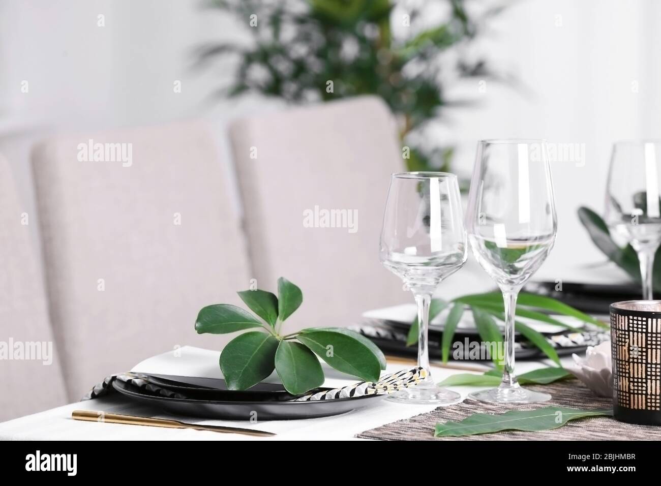 Beautiful table setting with green tropical leaves Stock Photo - Alamy