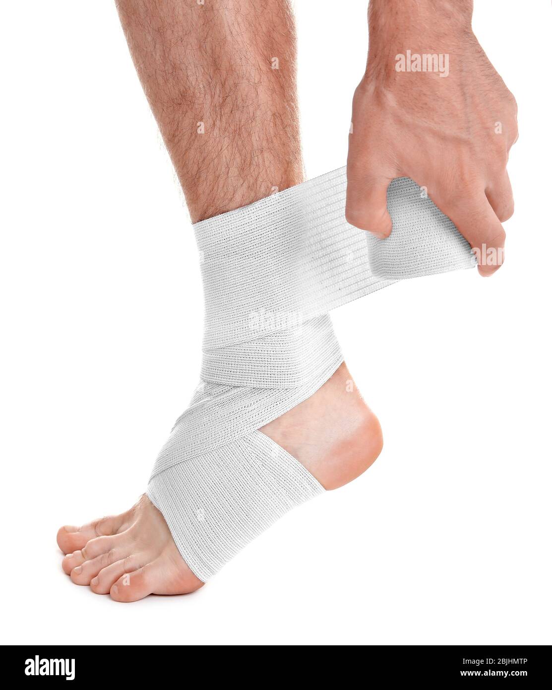 Young man applying bandage onto leg, on white background Stock Photo ...
