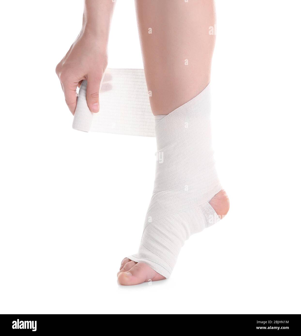 Young woman applying bandage onto leg, on white background Stock Photo ...