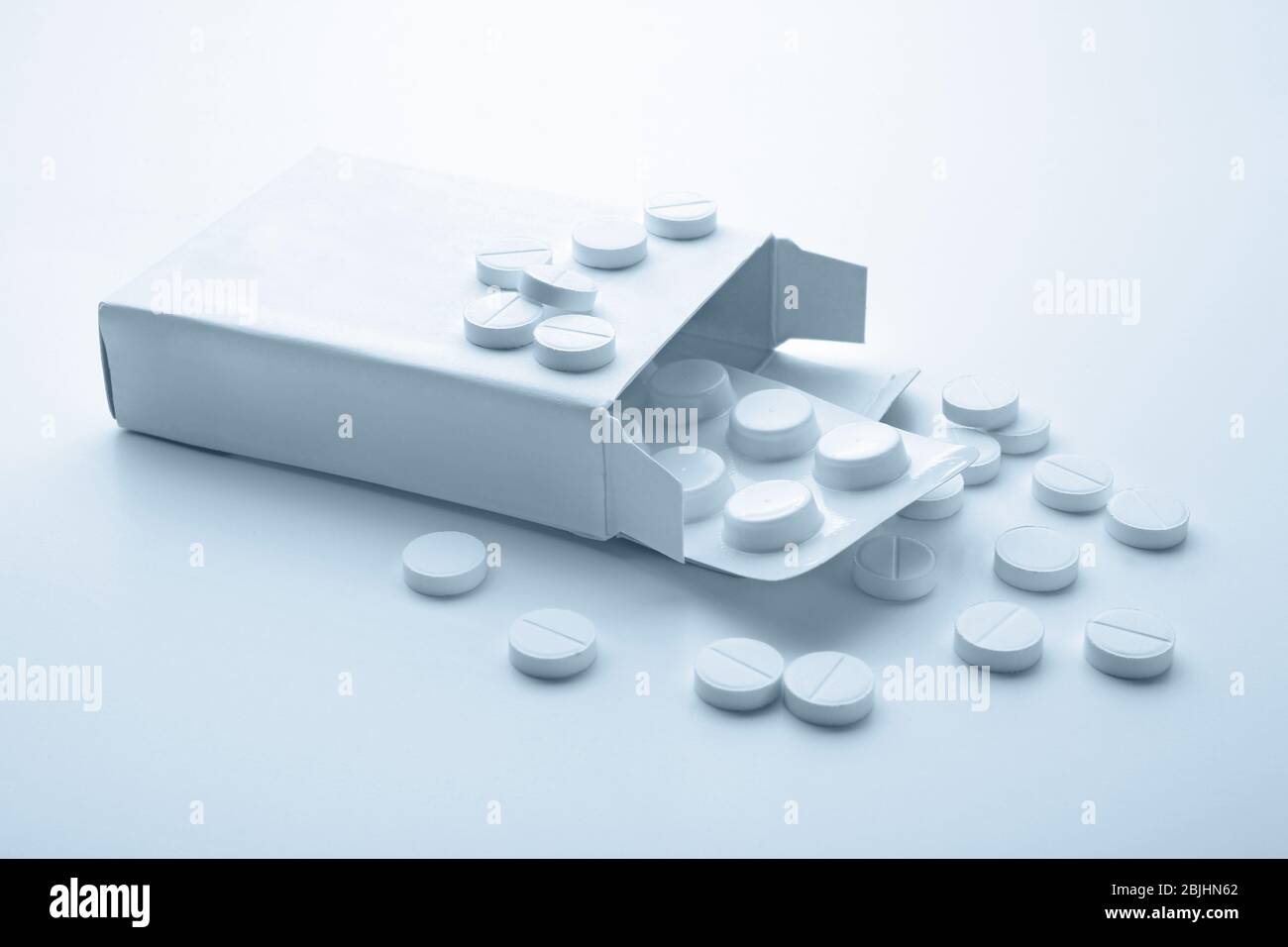 Package and scattered pills on white background Stock Photo - Alamy
