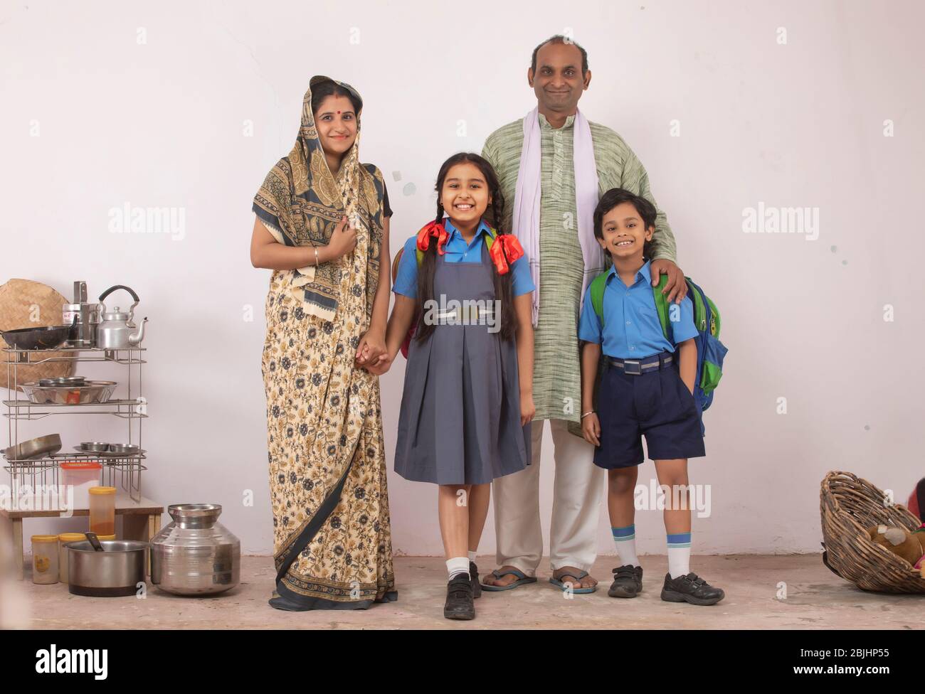 Indian Parents and their two children standing in front Stock Photo - Alamy