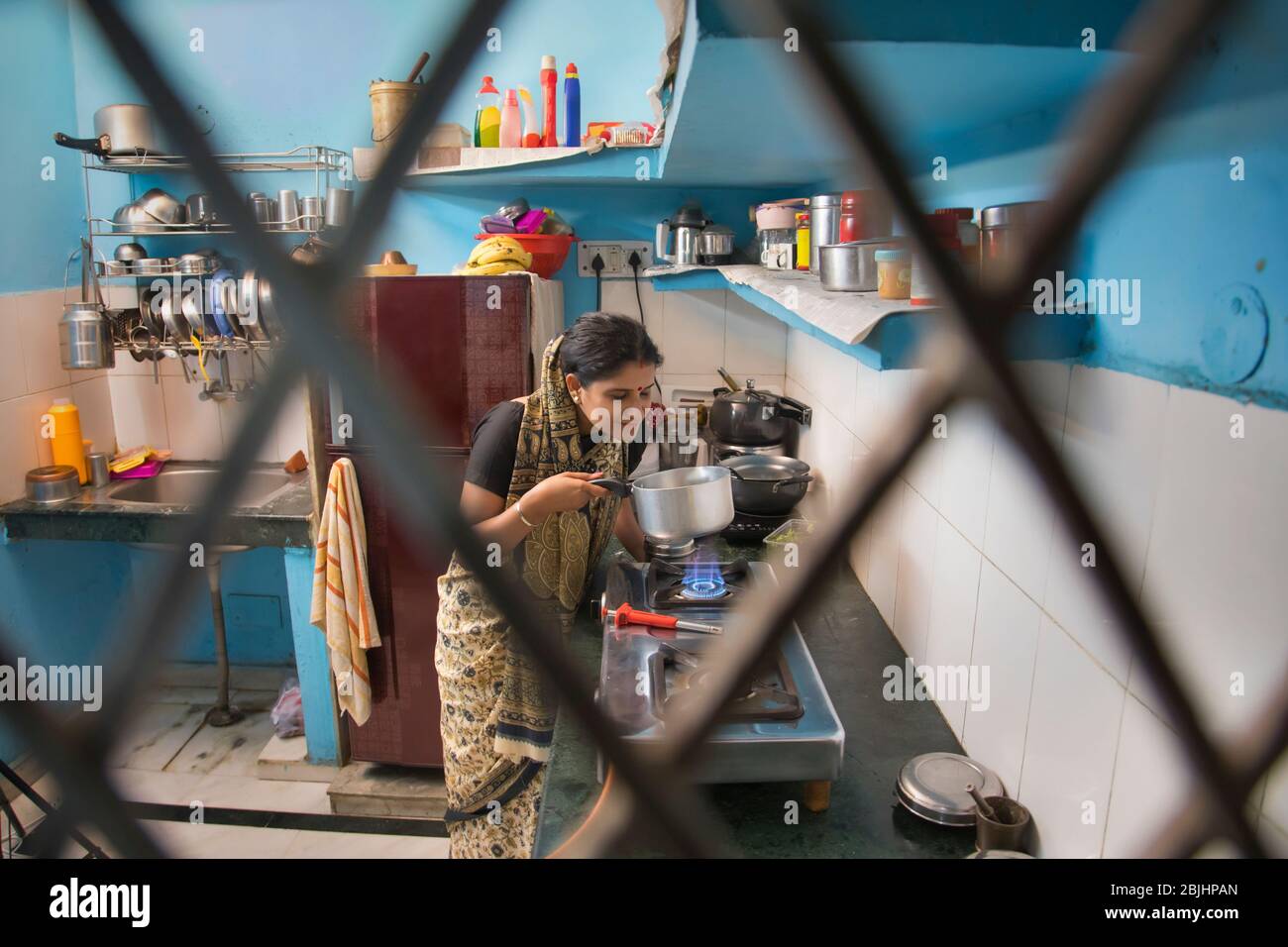 Indian Woman In Kitchen Cooking Food Stock Photo - Alamy