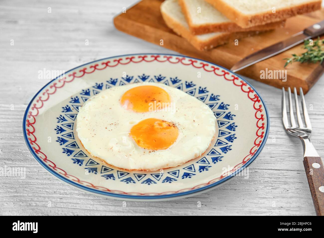 Homemade over easy fried eggs on plate Stock Photo - Alamy