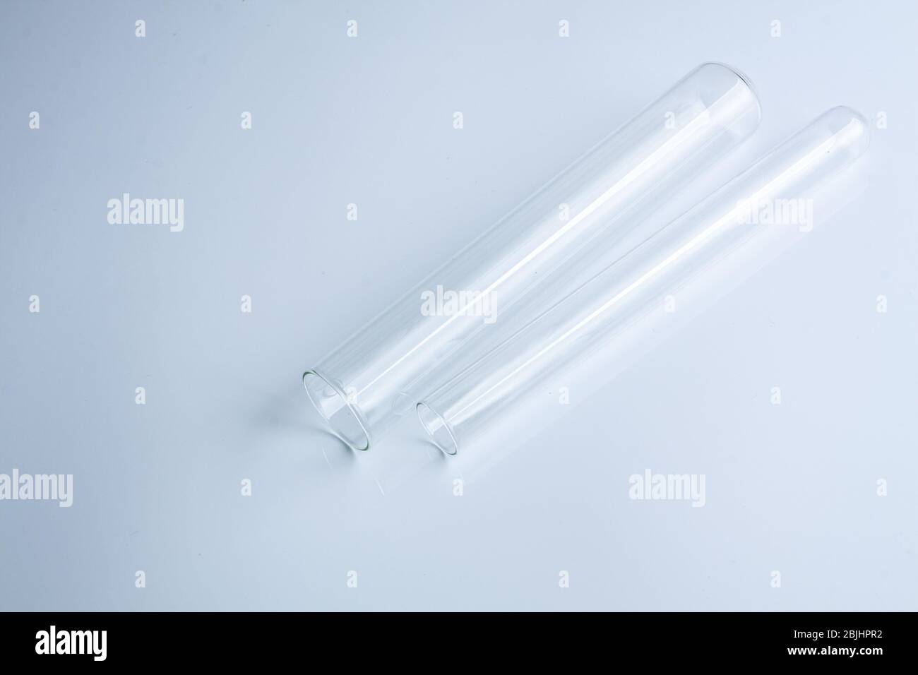 Science pipette with a pour of substance over laboratory test tubes ...